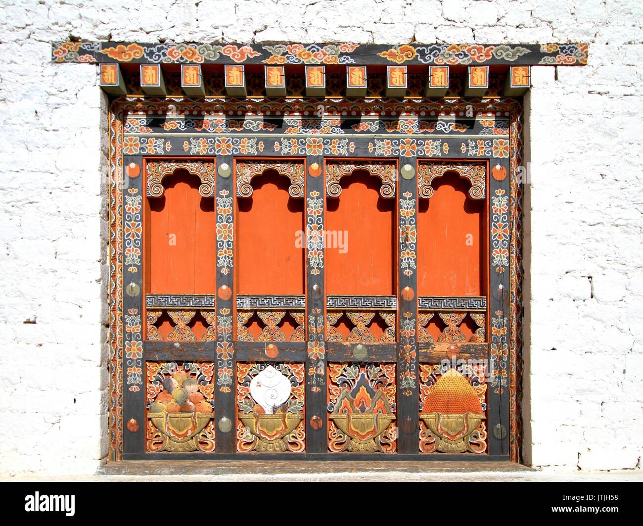 Traditional Bhutanese style building decorated with carved wood window ...