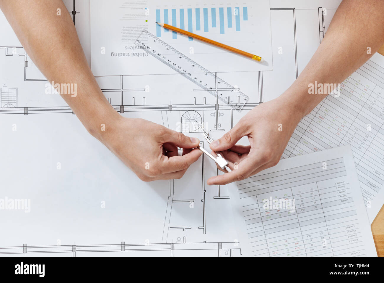 Flat lay photo of male hands creating engineering drawing Stock Photo ...