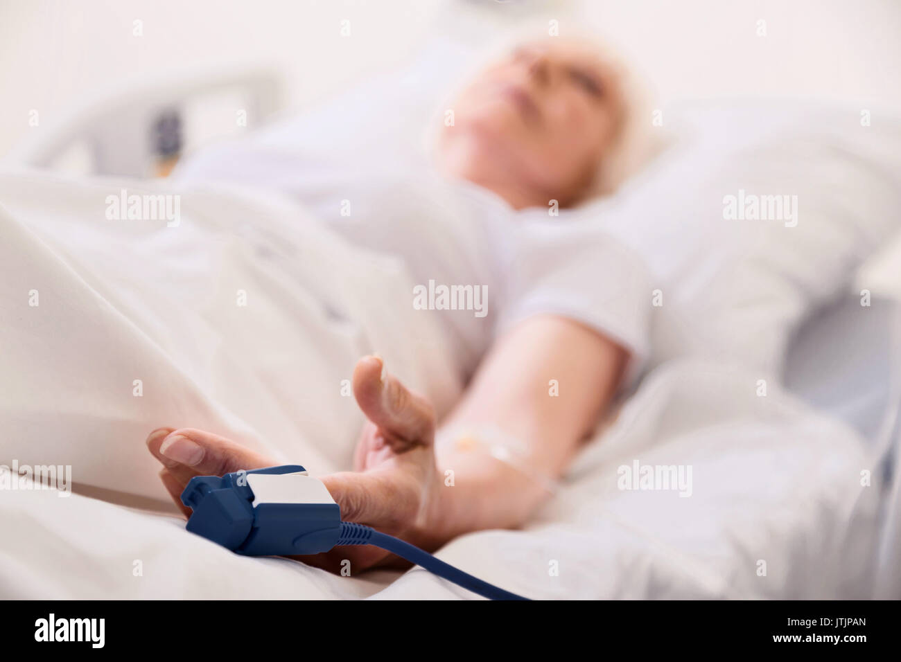Unstable feeble aged lady having her heart rate in check Stock Photo ...