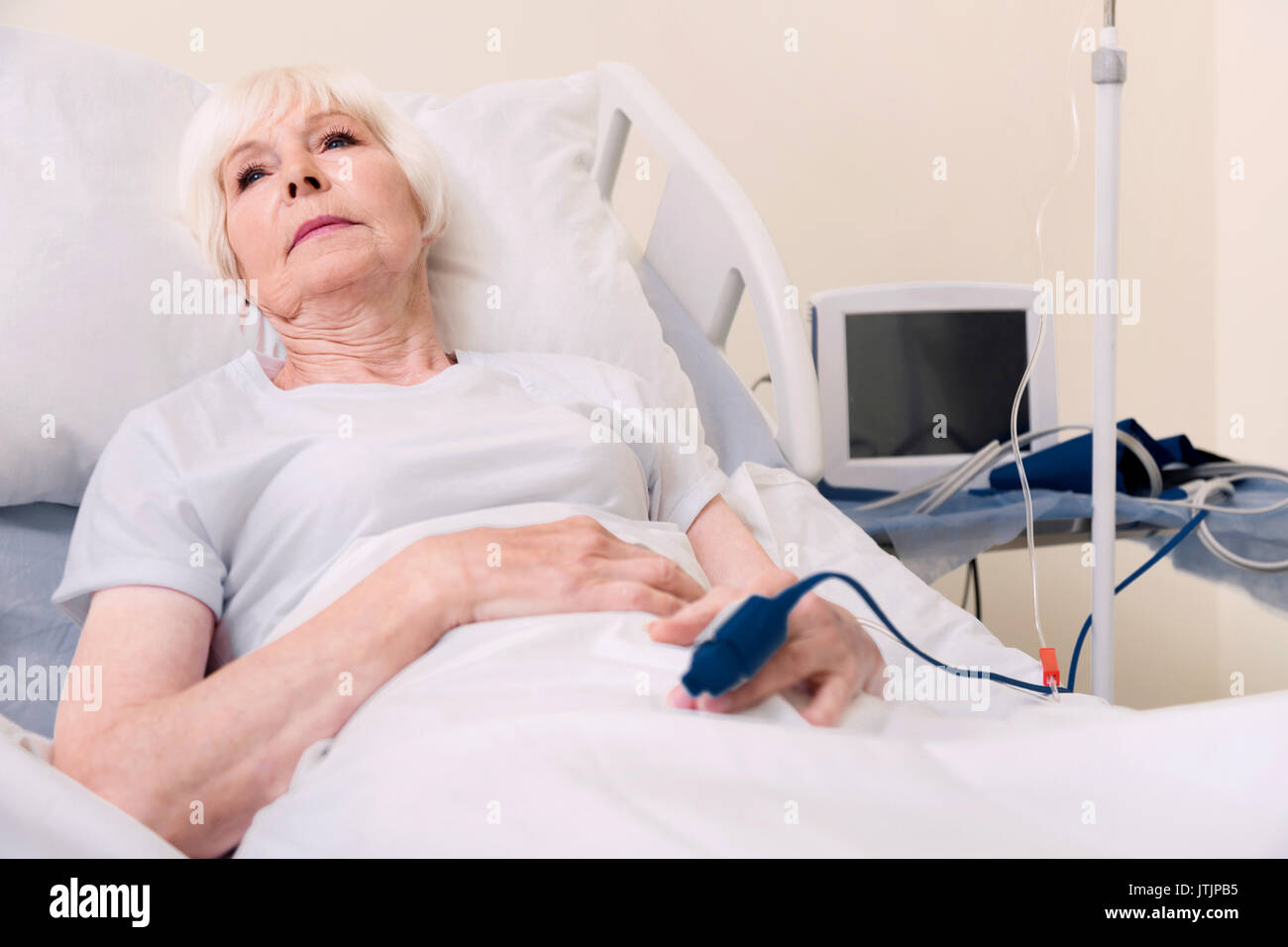 Sad fragile aged woman getting better after disease Stock Photo - Alamy