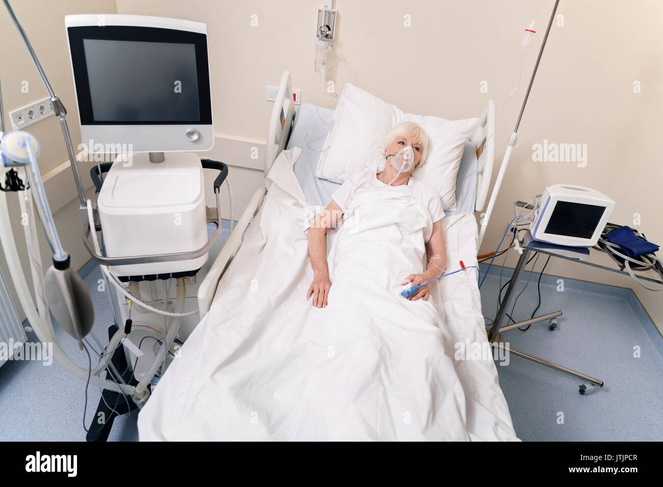 Sad ailing lady hoping going home soon Stock Photo - Alamy