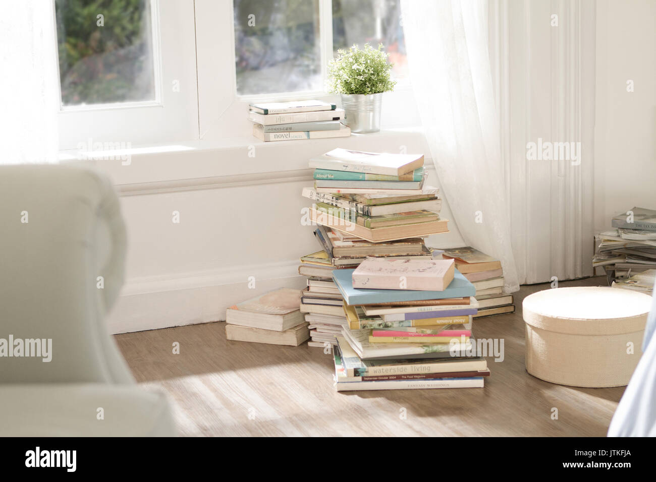 a lot of books pile by the window in the bedroom Stock Photo - Alamy