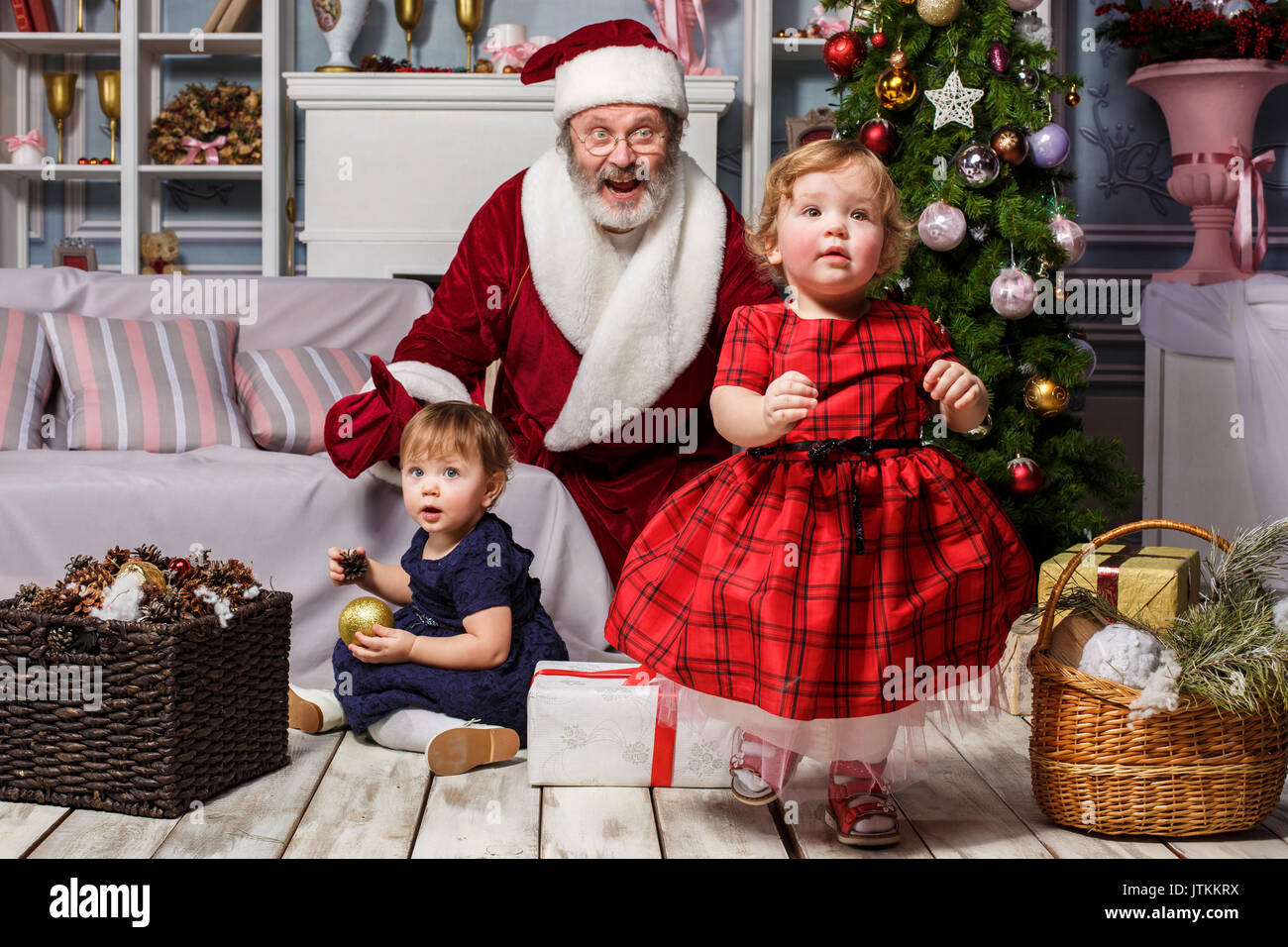 The two little girls with Santa at studio with christmas decorations ...