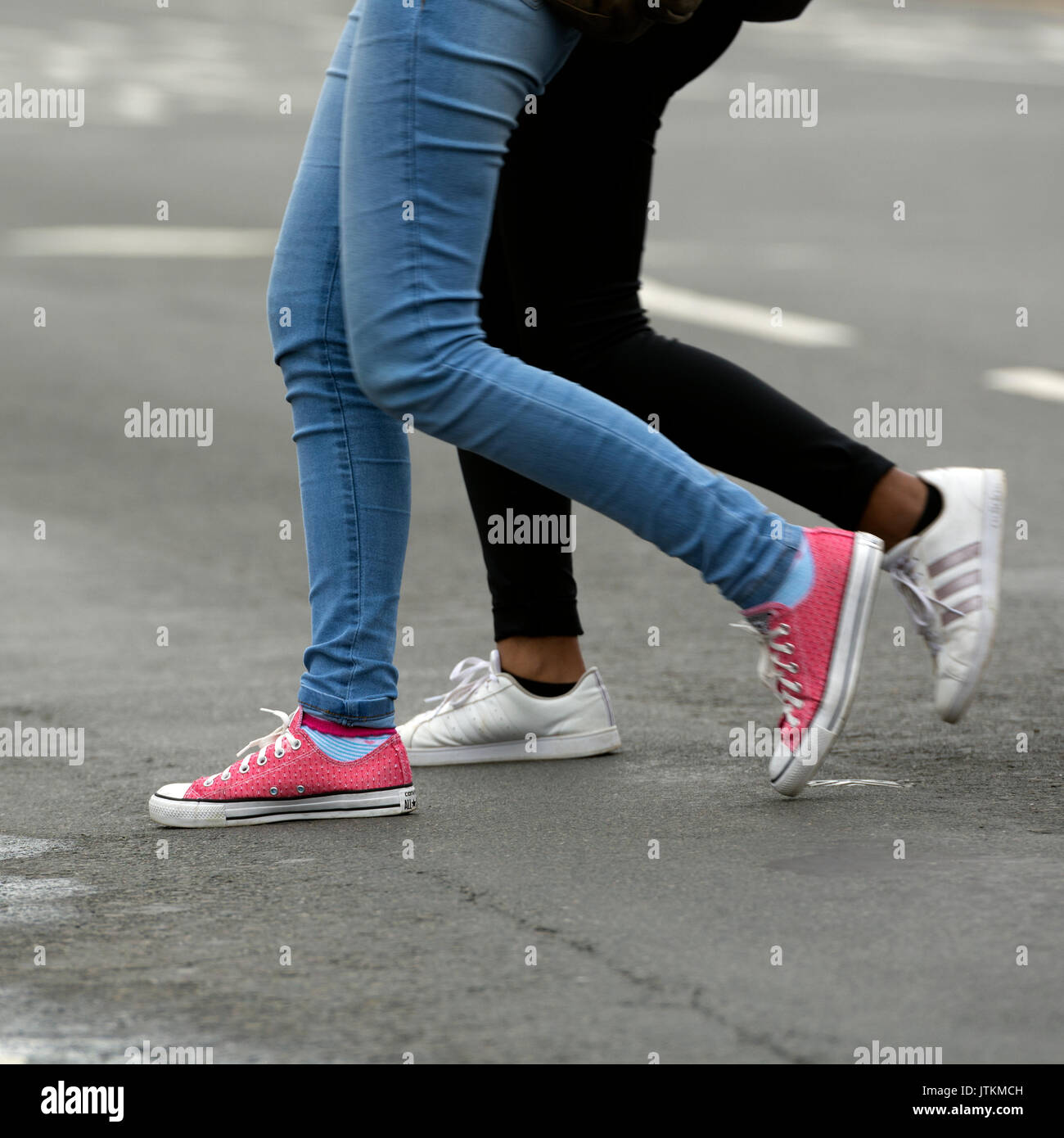 Two teenage girls walking in step Stock Photo - Alamy