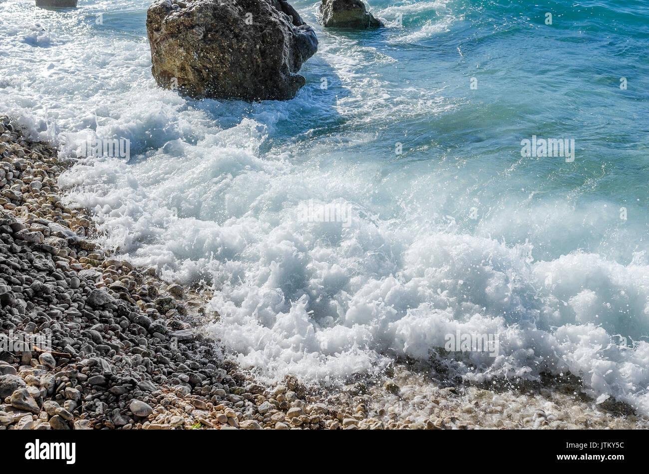 Sea wave is broken about stones Stock Photo - Alamy