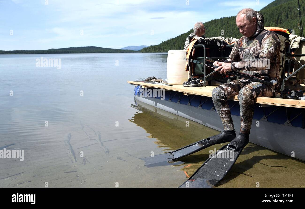 Russian President Vladimir Putin wearing a camouflage wetsuit prepares ...