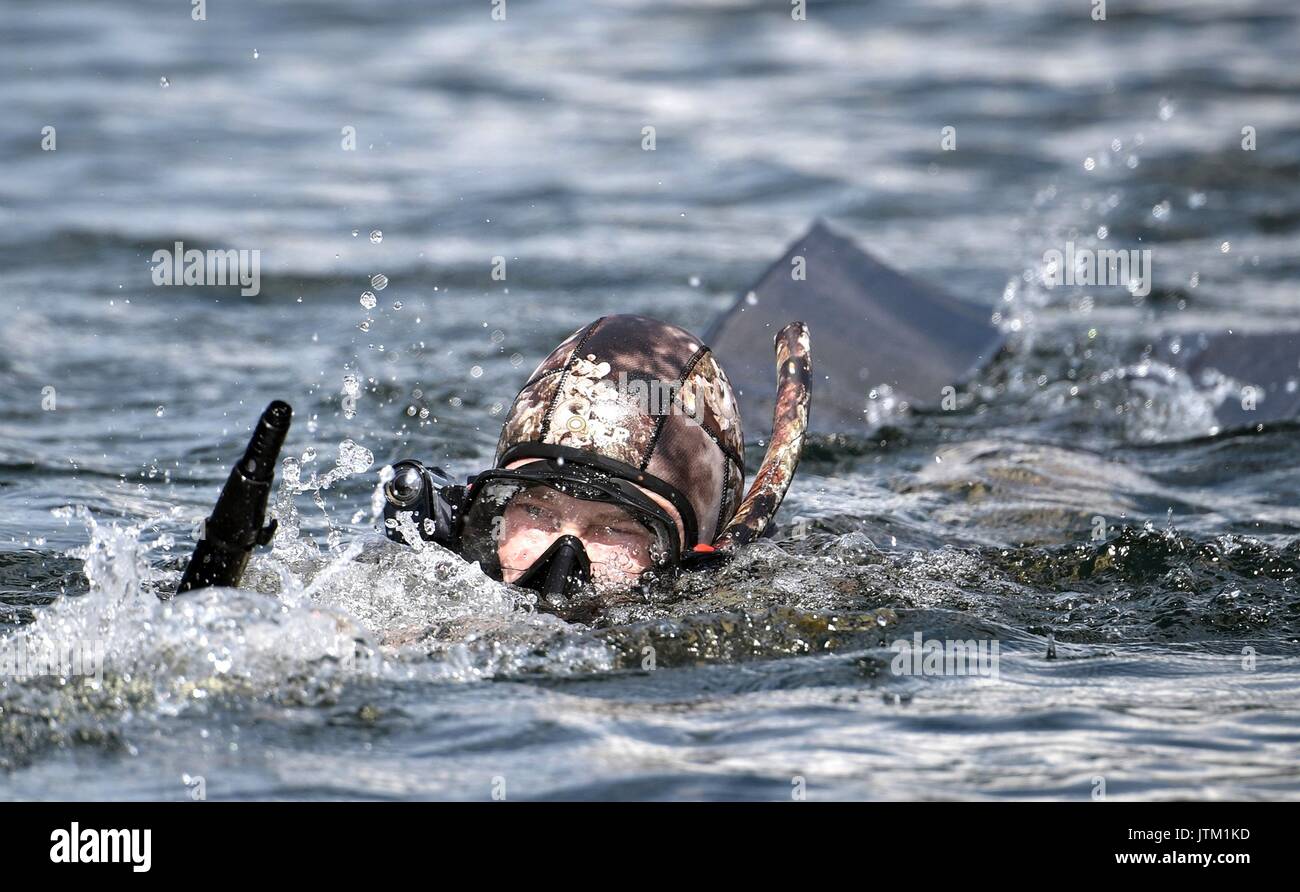 Russian President Vladimir Putin wearing a camouflage wetsuit ...