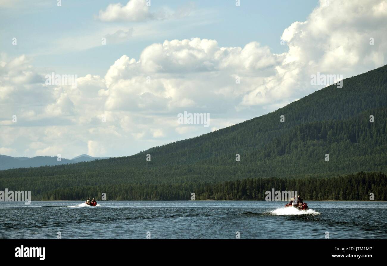 Russian President Vladimir Putin and his entourage ride in boats after ...