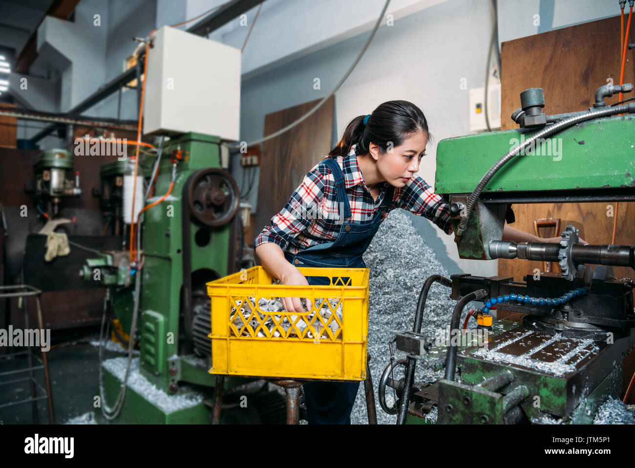 professional milling machine female employee seriously put yellow ...