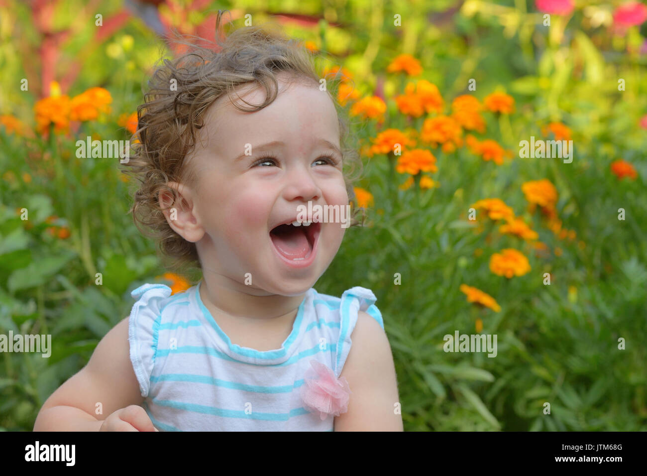 baby girl laughing in nature Stock Photo - Alamy