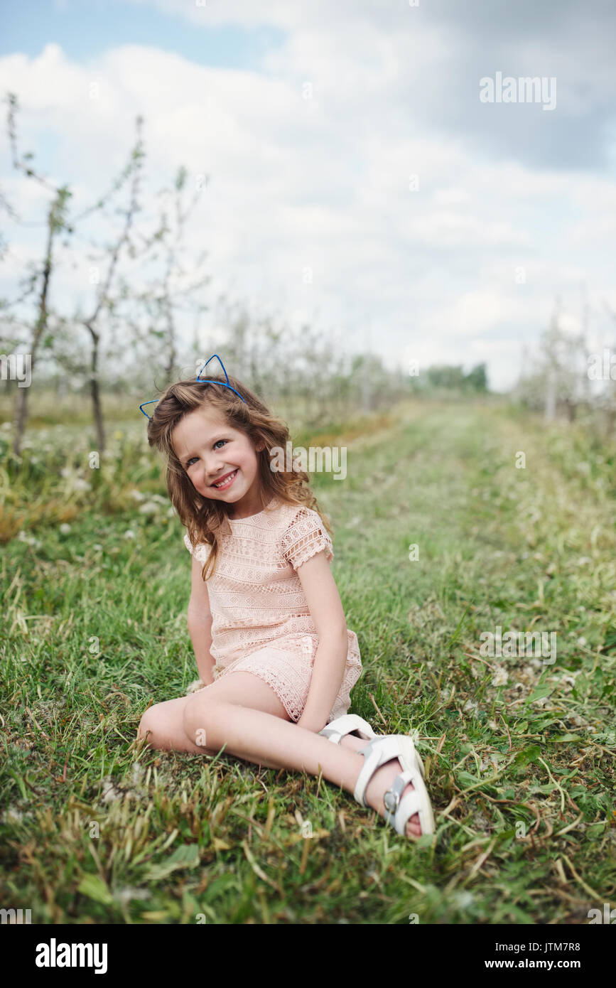 beautiful little girl in blooming garden Stock Photo - Alamy