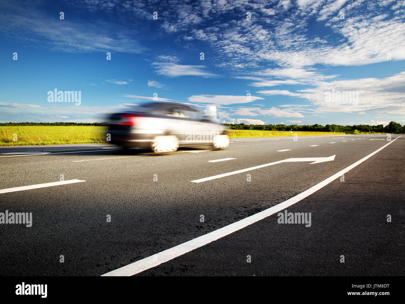 Car on asphalt road in beautiful spring day Stock Photo - Alamy