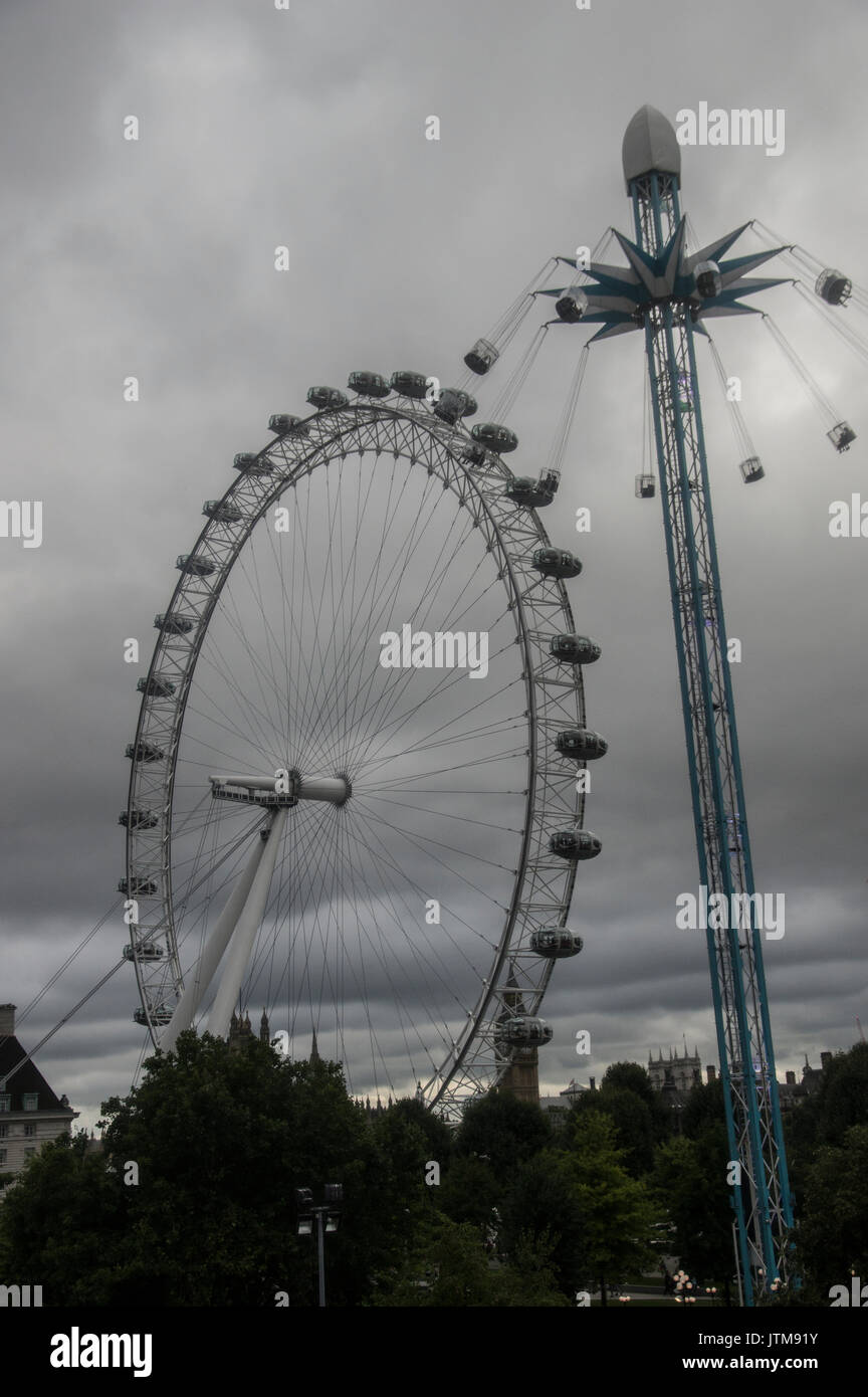 Overcast, cloudy day in London with a view of an amusement park ride ...