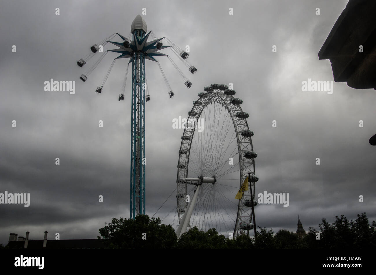 Overcast, cloudy day in London with a view of an amusement park ride ...
