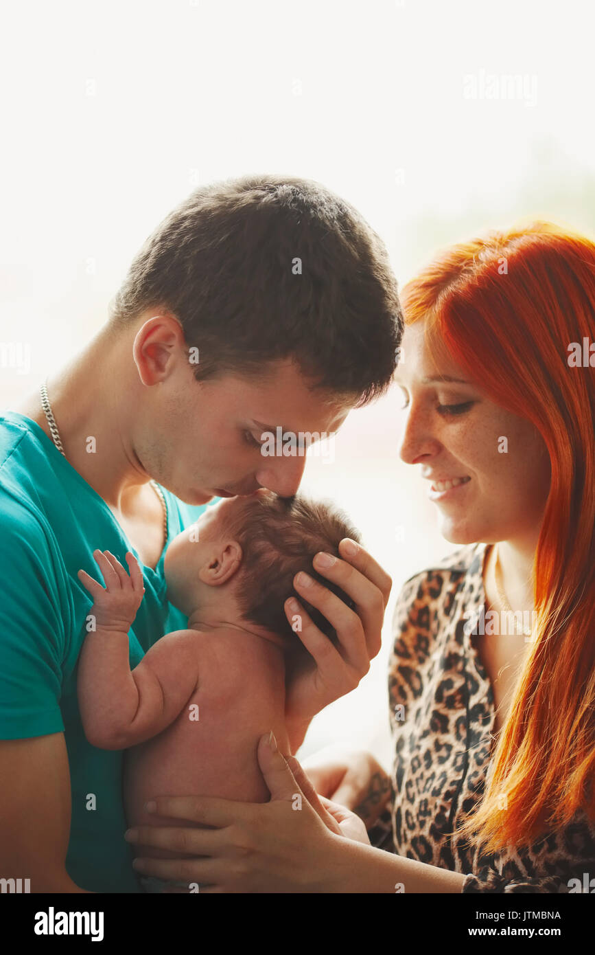 Parents smiling holding little baby hi-res stock photography and images ...