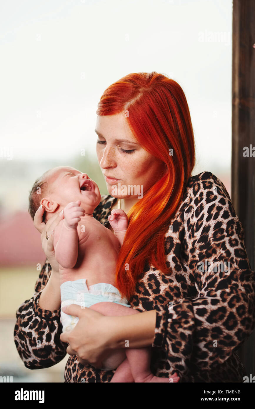 Sad mother holding baby hi-res stock photography and images - Alamy