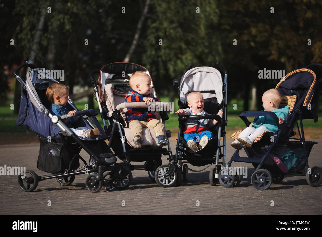 funny children sitting in strollers in park Stock Photo - Alamy