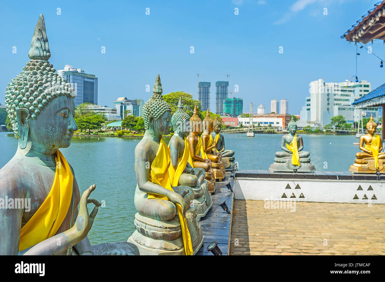 The row of Lord Buddha statues along the platform on Beira lake are the ...