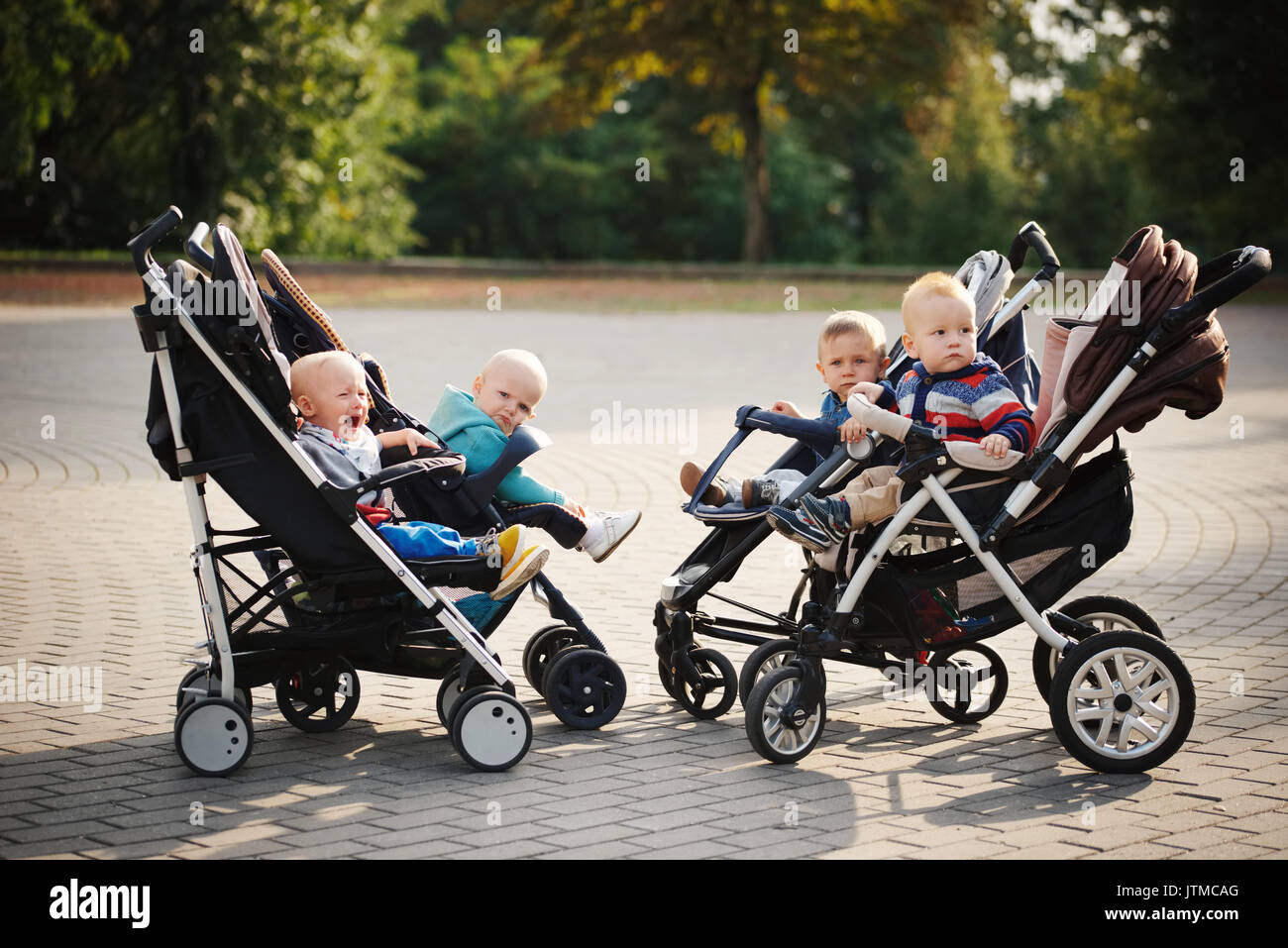 funny children sitting in strollers in park Stock Photo - Alamy