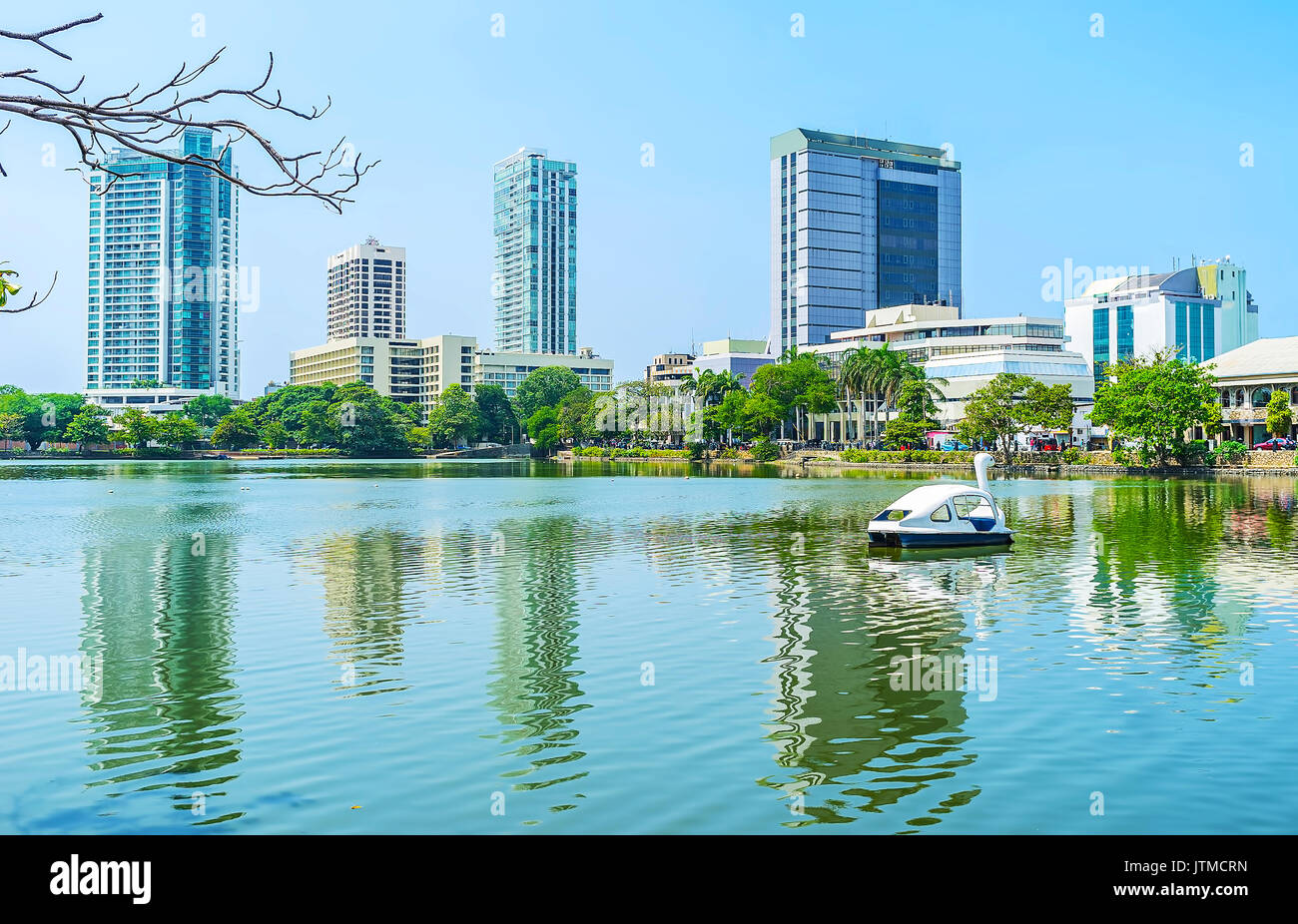The swan catamaran in Beira lake with the modern business district on ...