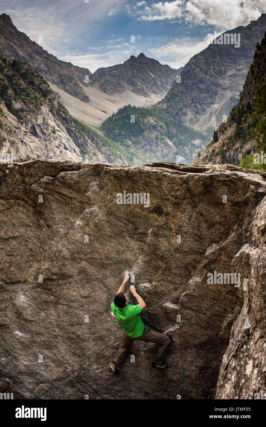 Young man climbs boulders in the Alfroide valley, French Alps Stock ...