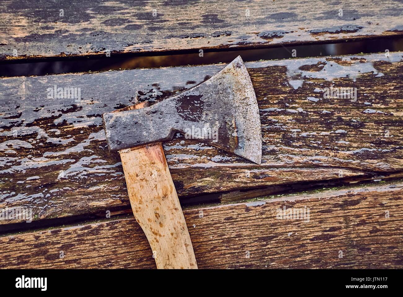 Axe on wet planks Stock Photo - Alamy