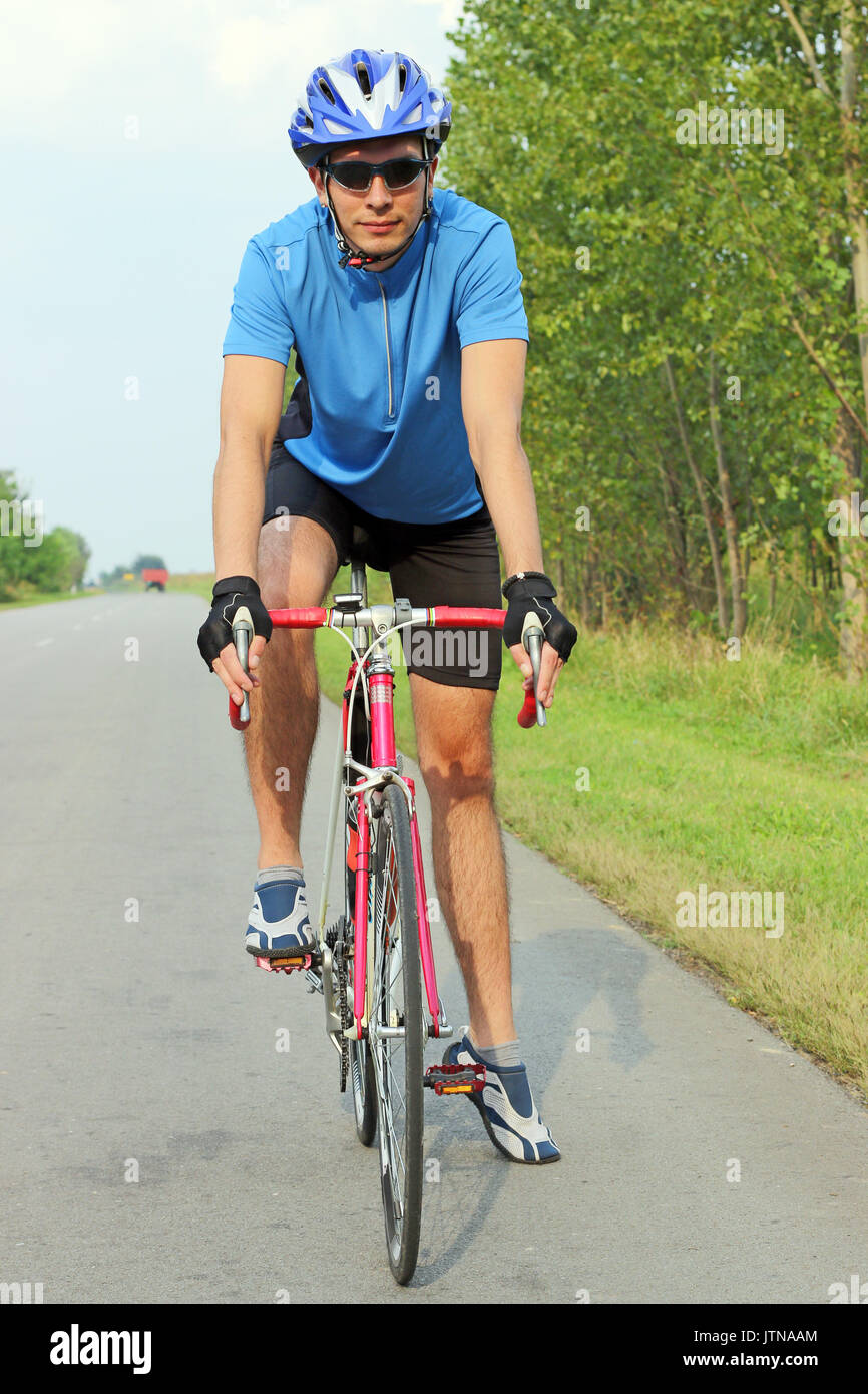 male cyclist riding a bike on an open road Stock Photo - Alamy