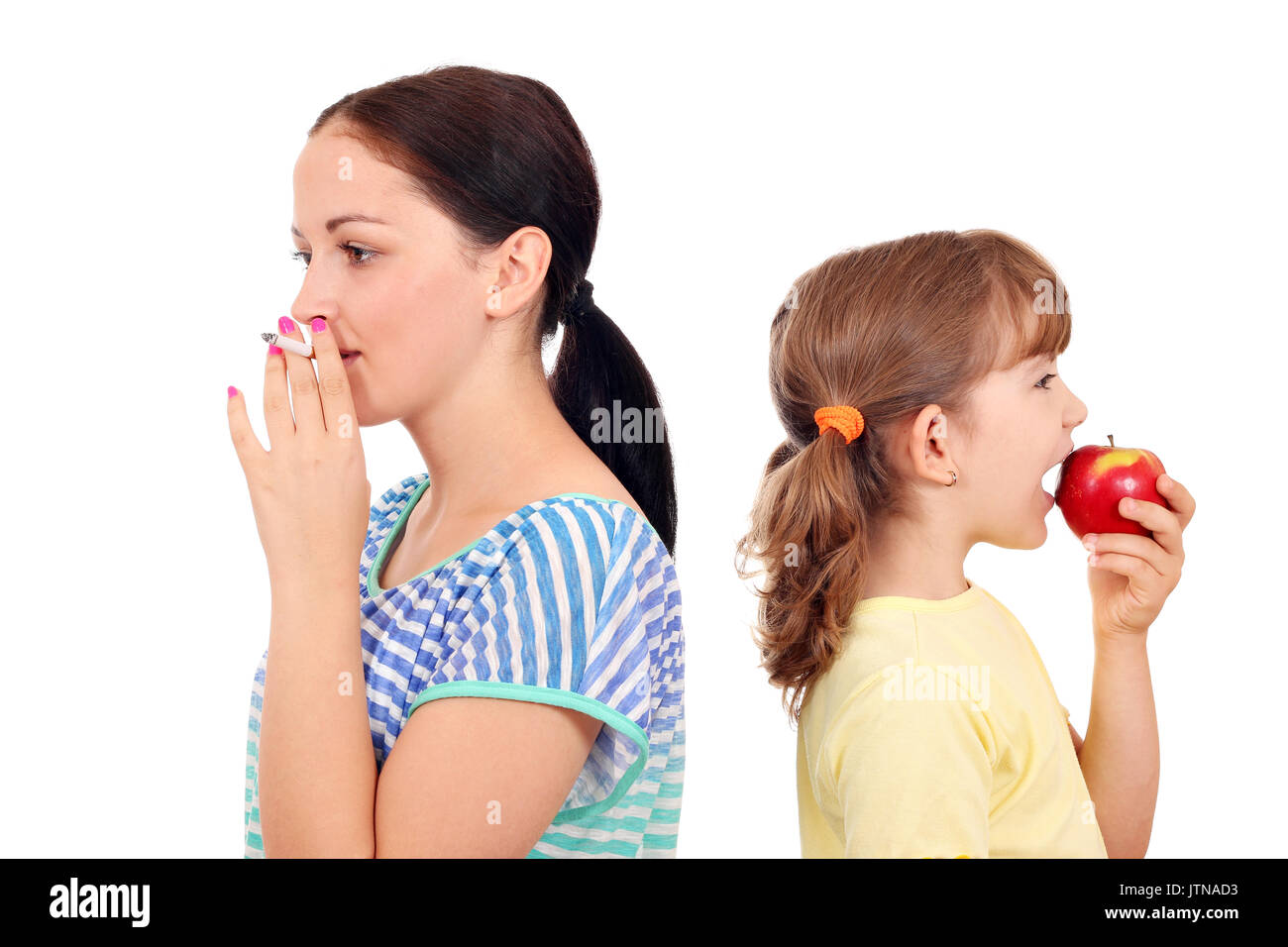 girl smoking a cigarette and little girl eating an apple Stock Photo ...