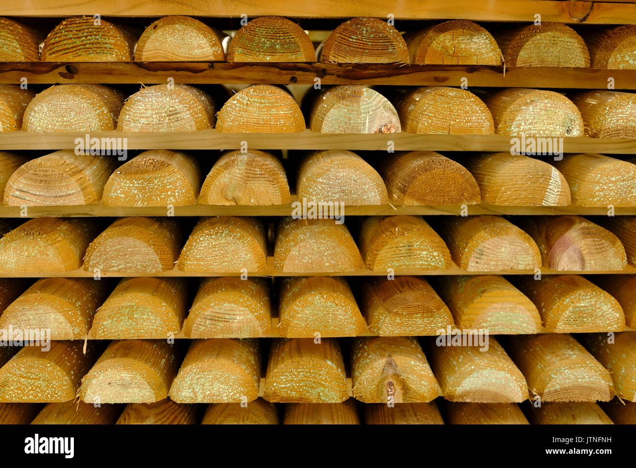 Stacks of wooden rounded border edging for garden flower beds Stock ...