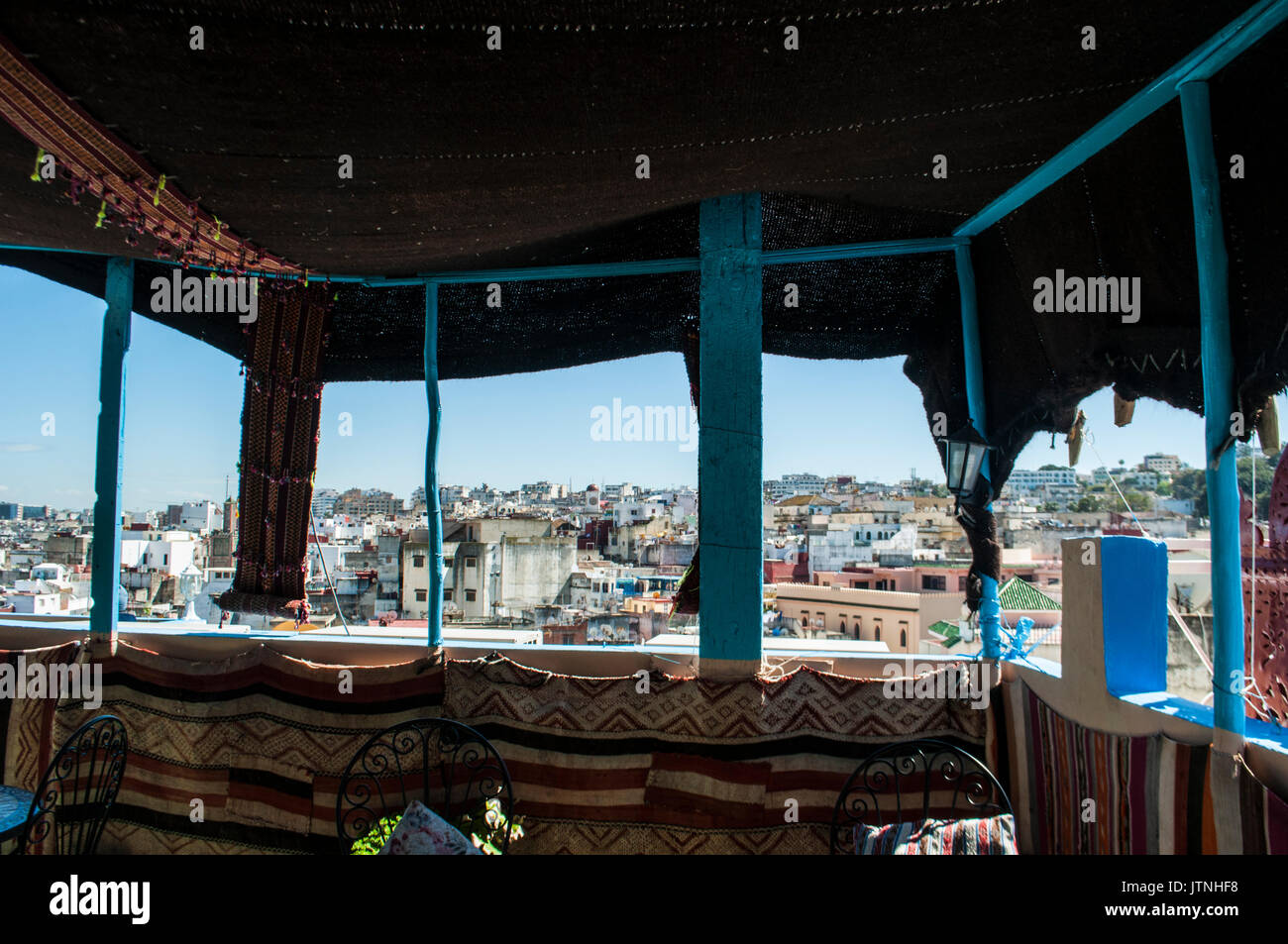 A typical moroccan terrace with view on the roofs and the skyline of ...