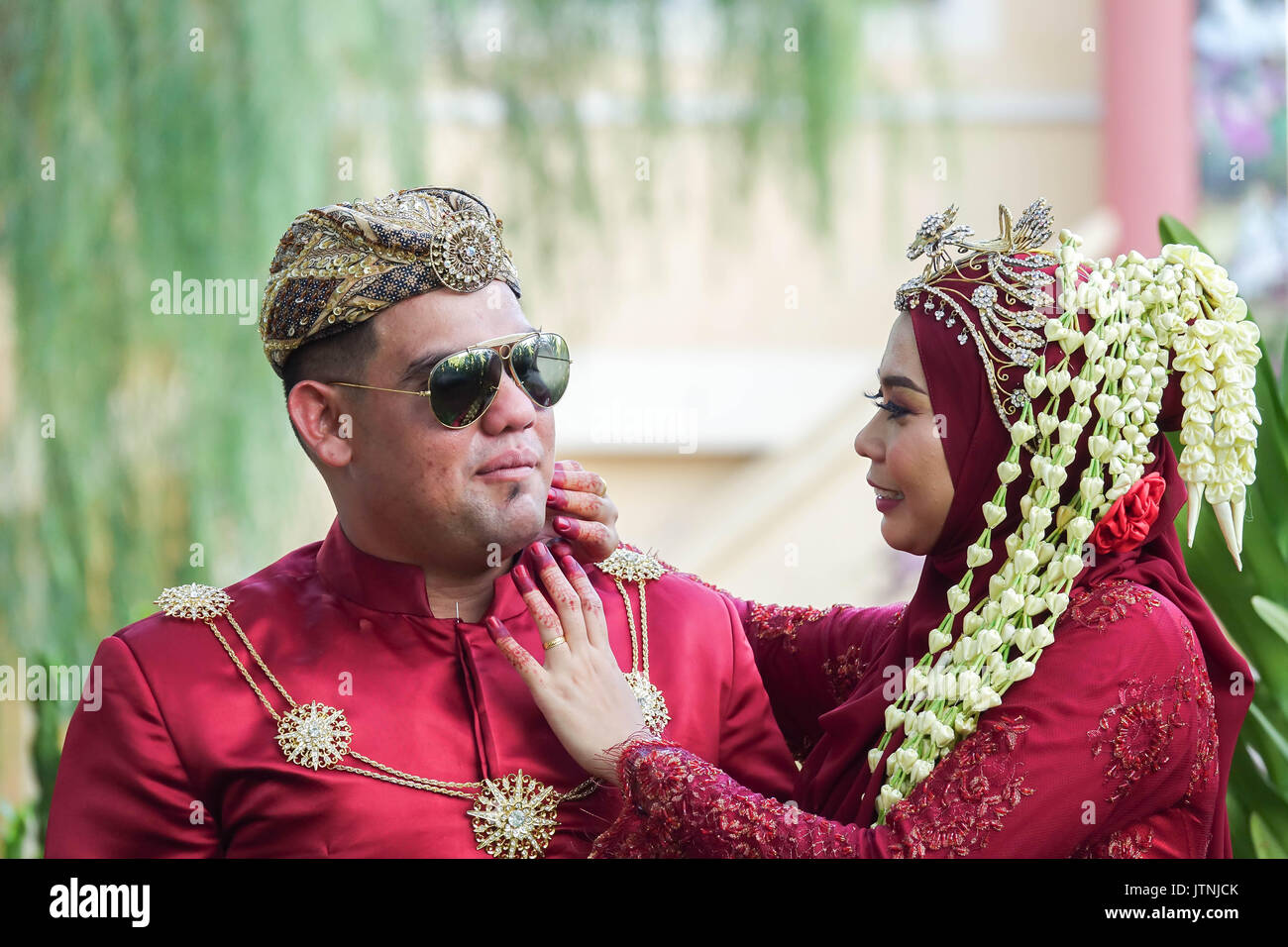 Traditional javanese wedding couple bride and bridegroom at garden ...