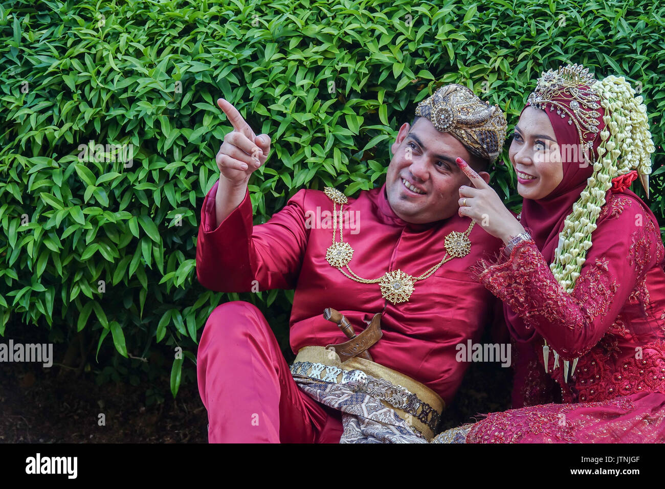 Traditional javanese wedding couple bride and bridegroom at garden ...