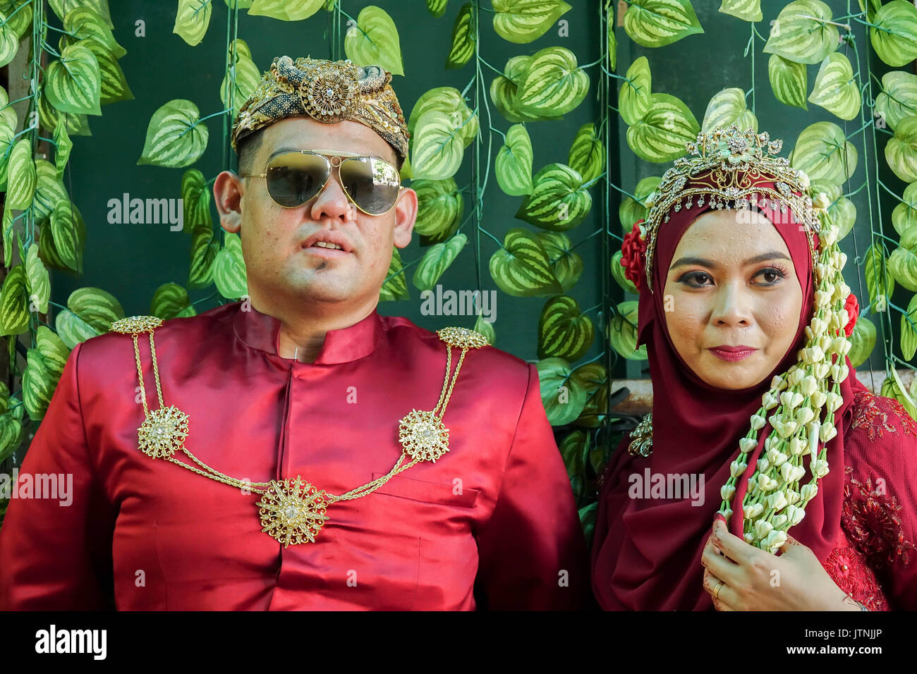 Traditional javanese wedding couple bride and bridegroom at garden ...