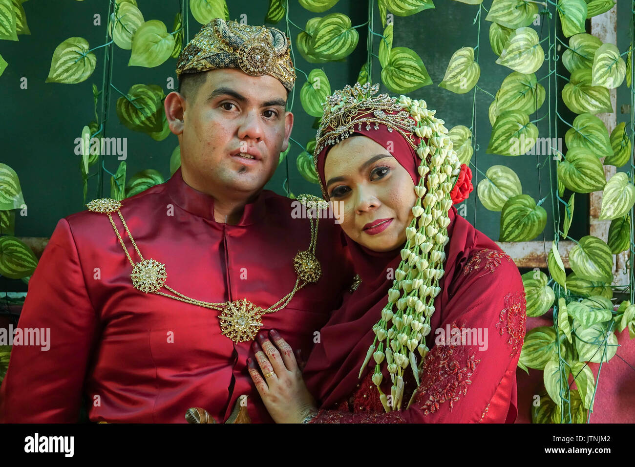 Traditional javanese wedding couple bride and bridegroom at garden ...