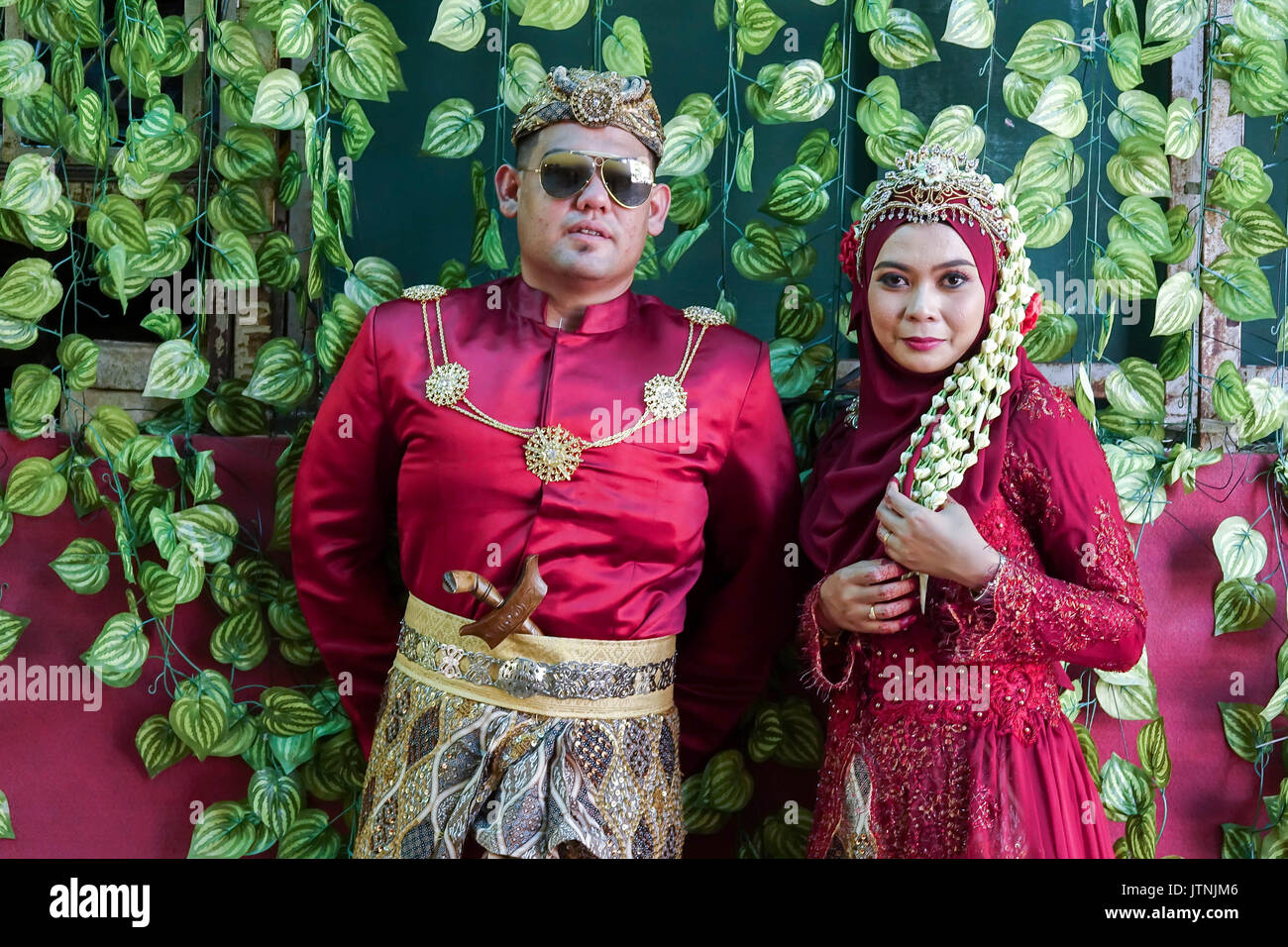 Traditional javanese wedding couple bride and bridegroom at garden ...
