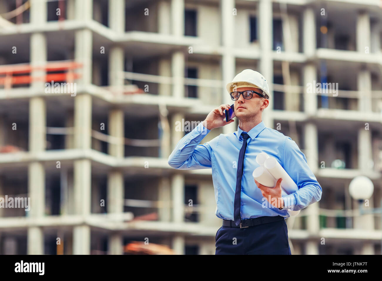 Construction engineer at the construction site looking at the camera ...