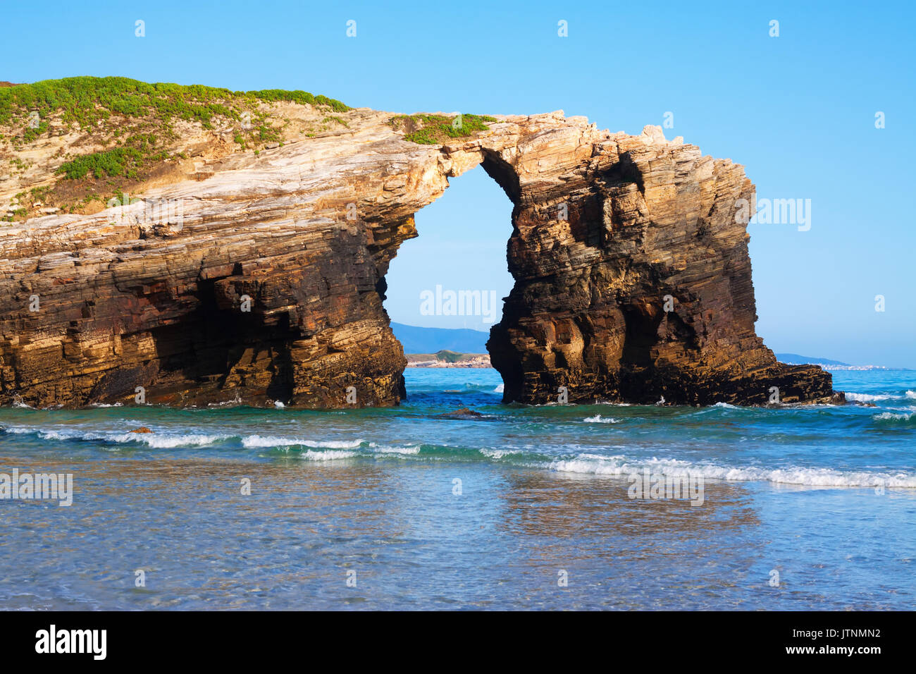 Natural arch at beach in summer day. Atlantic Ocean coast of Spain ...