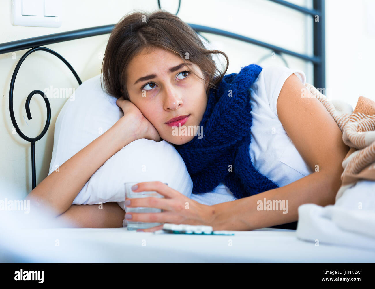 Sad teenage girl with high fever and flu in bed Stock Photo - Alamy