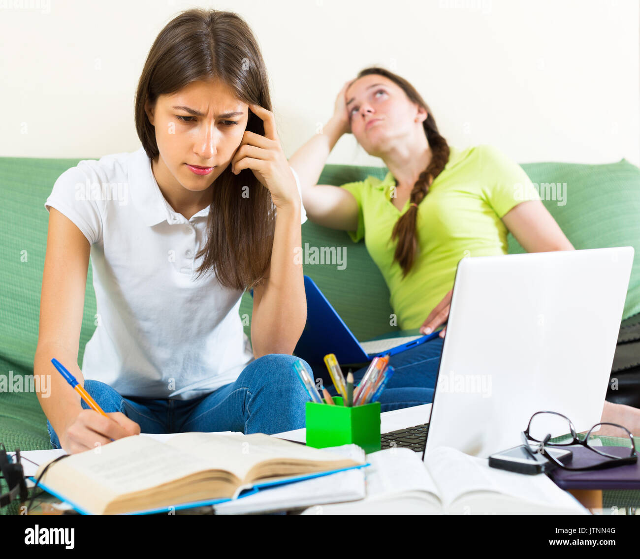 Portrait of sad students studying at home Stock Photo - Alamy