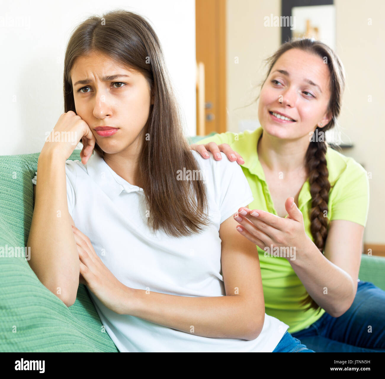 Girl cheering up her deeply upset friend suffering from relationship ...