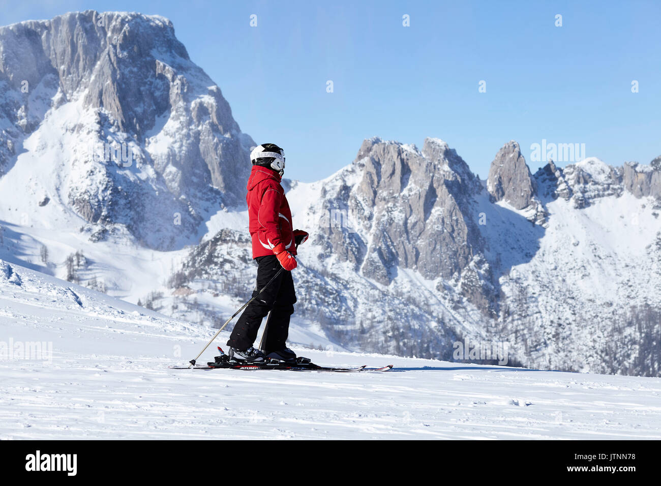 Skier standing in ski mountain resort Stock Photo - Alamy