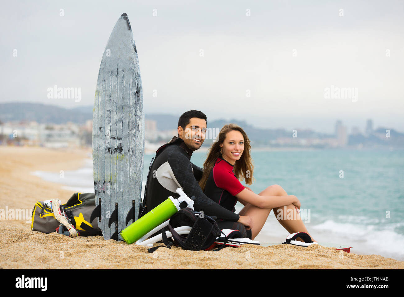 Happy surfers family on the beach in wetsuits Stock Photo - Alamy