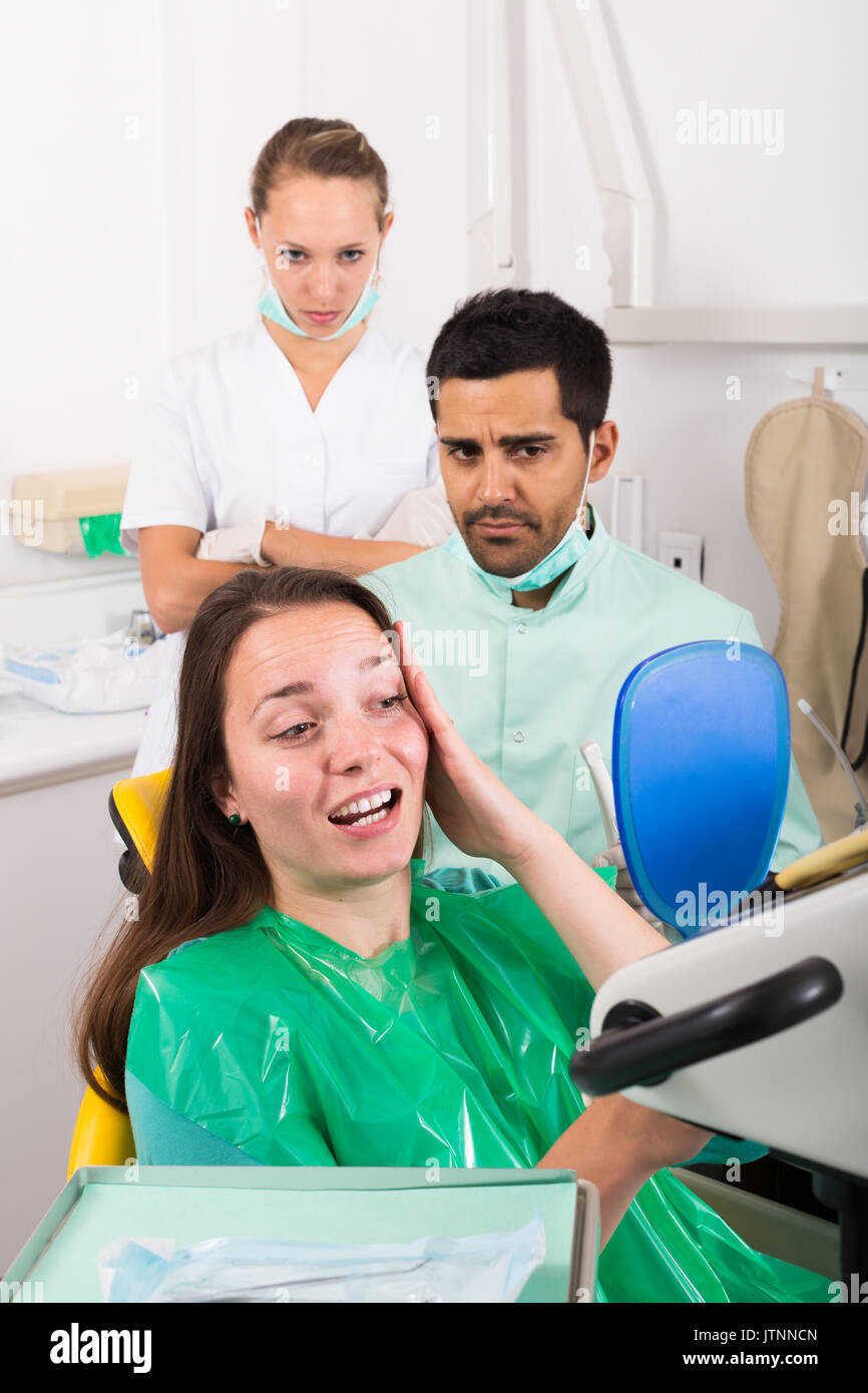 Scared woman patient treating at the dental hospital Stock Photo - Alamy