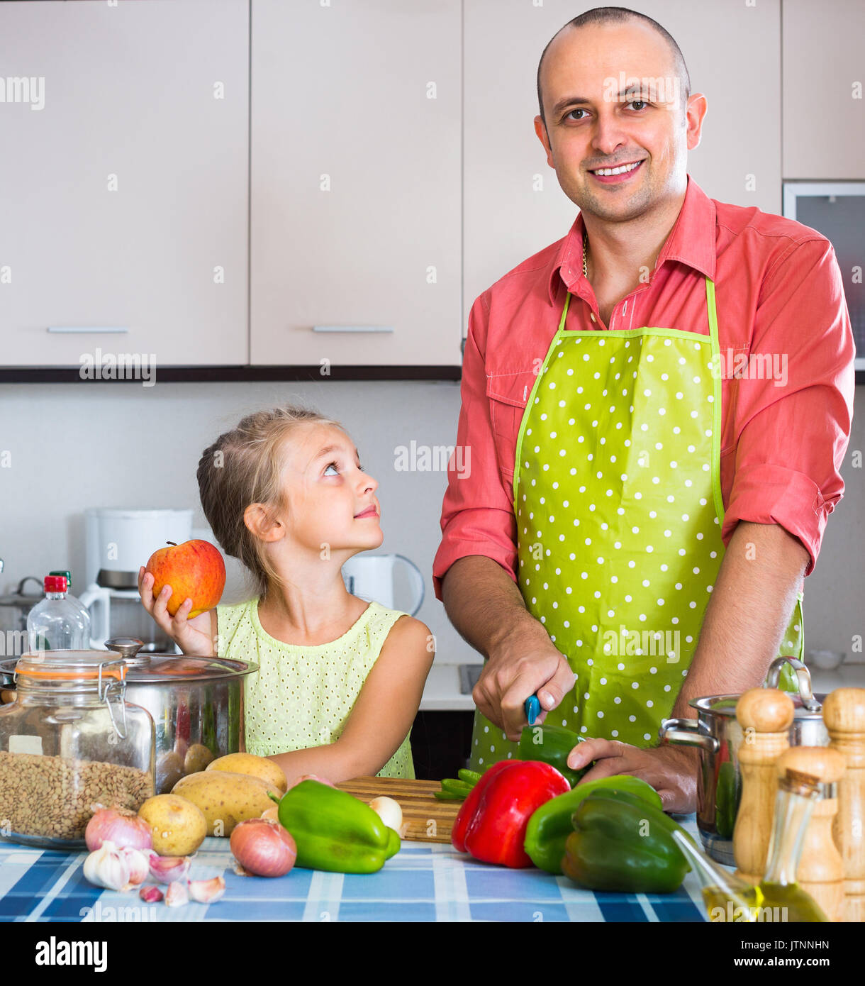 Adult man and happy child cooking in domestic kitchen Stock Photo - Alamy