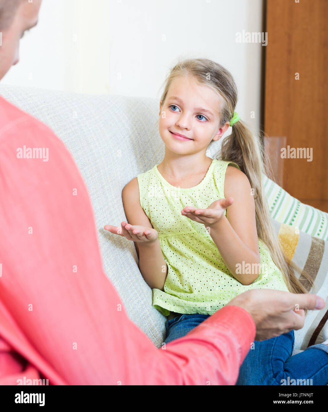 Cute little girl talking with dad about something interesting Stock ...