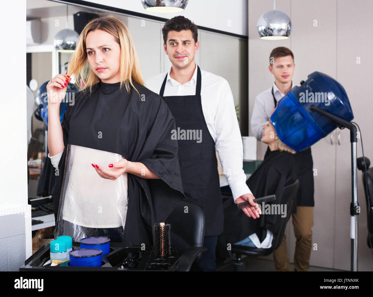 Beautiful angry woman blaming hairdresser in bad haircut Stock Photo ...