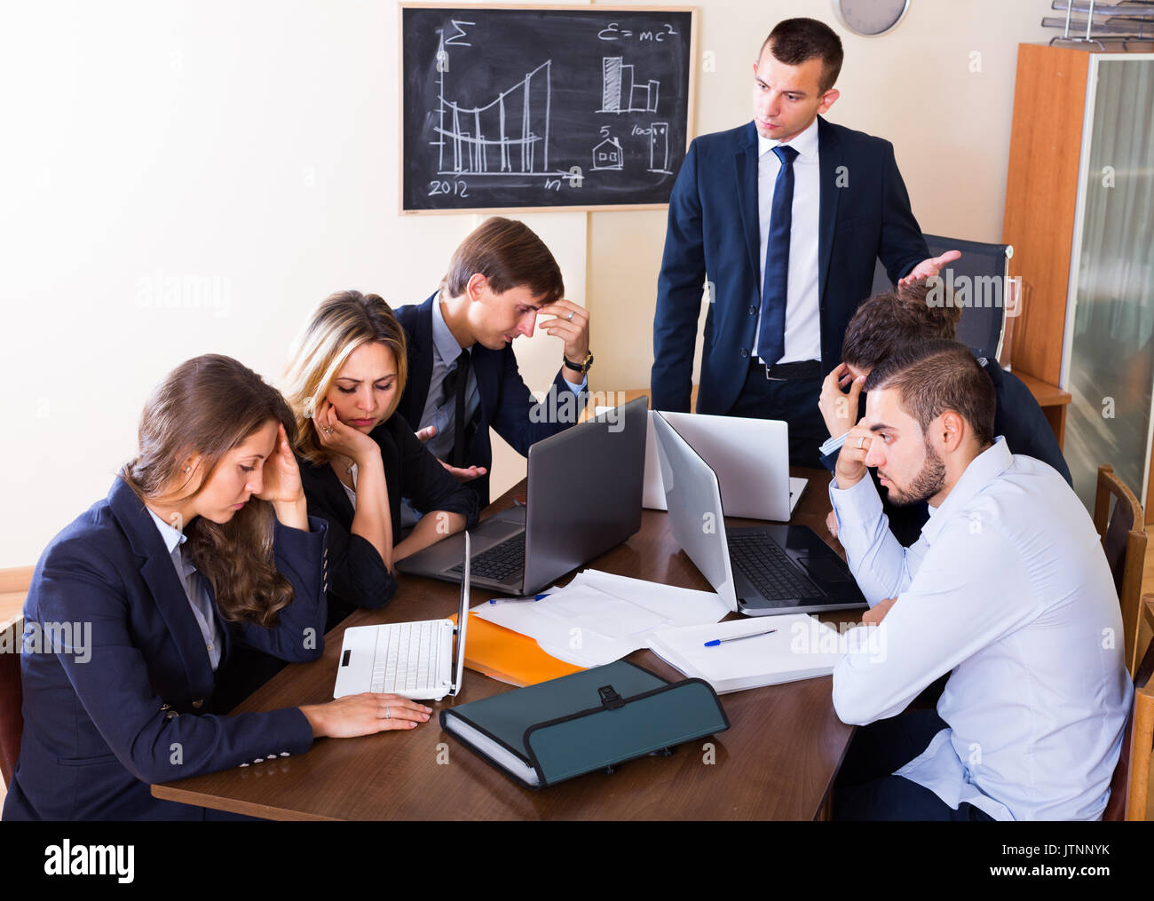 Manager shouting to employees at group meeting indoors Stock Photo - Alamy