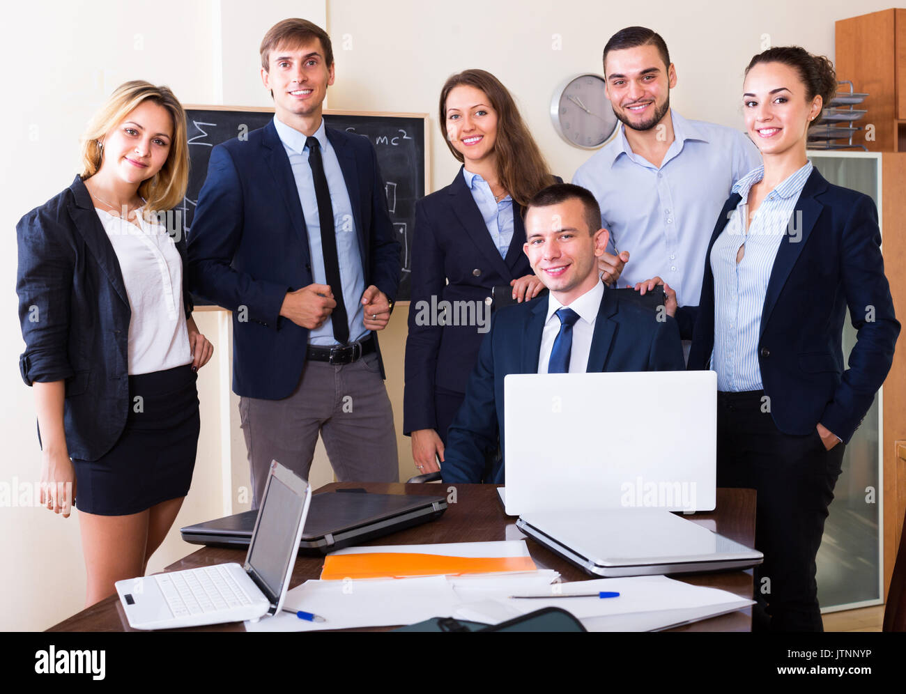 Portrait of positive corporate managers in office interior Stock Photo ...
