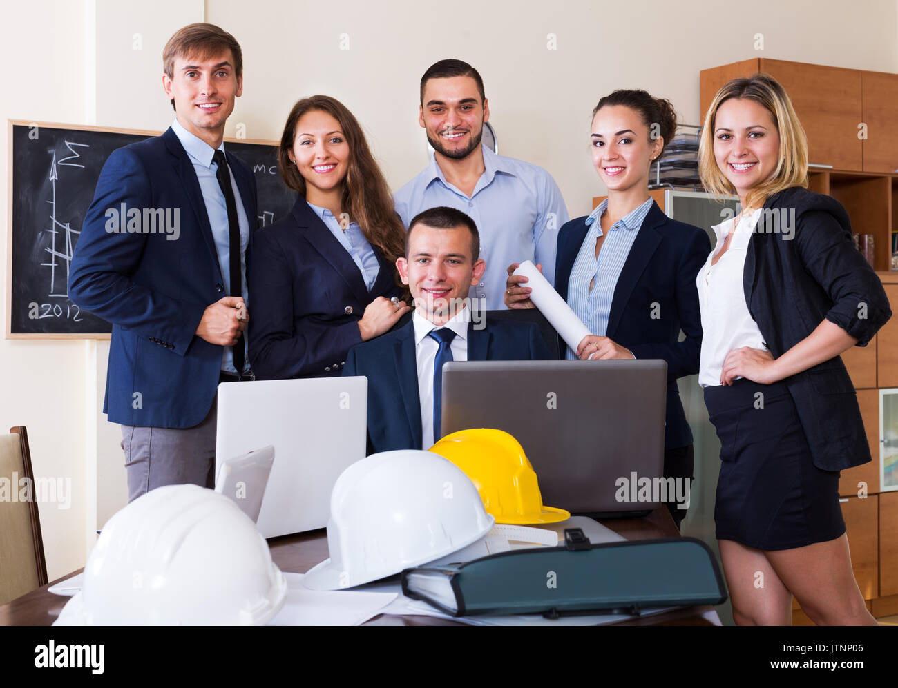 Professional planners with helmets posing in architecture bureau Stock ...