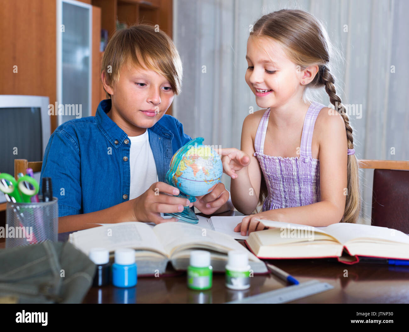 Big brother helping little girl to do homework at home Stock Photo - Alamy